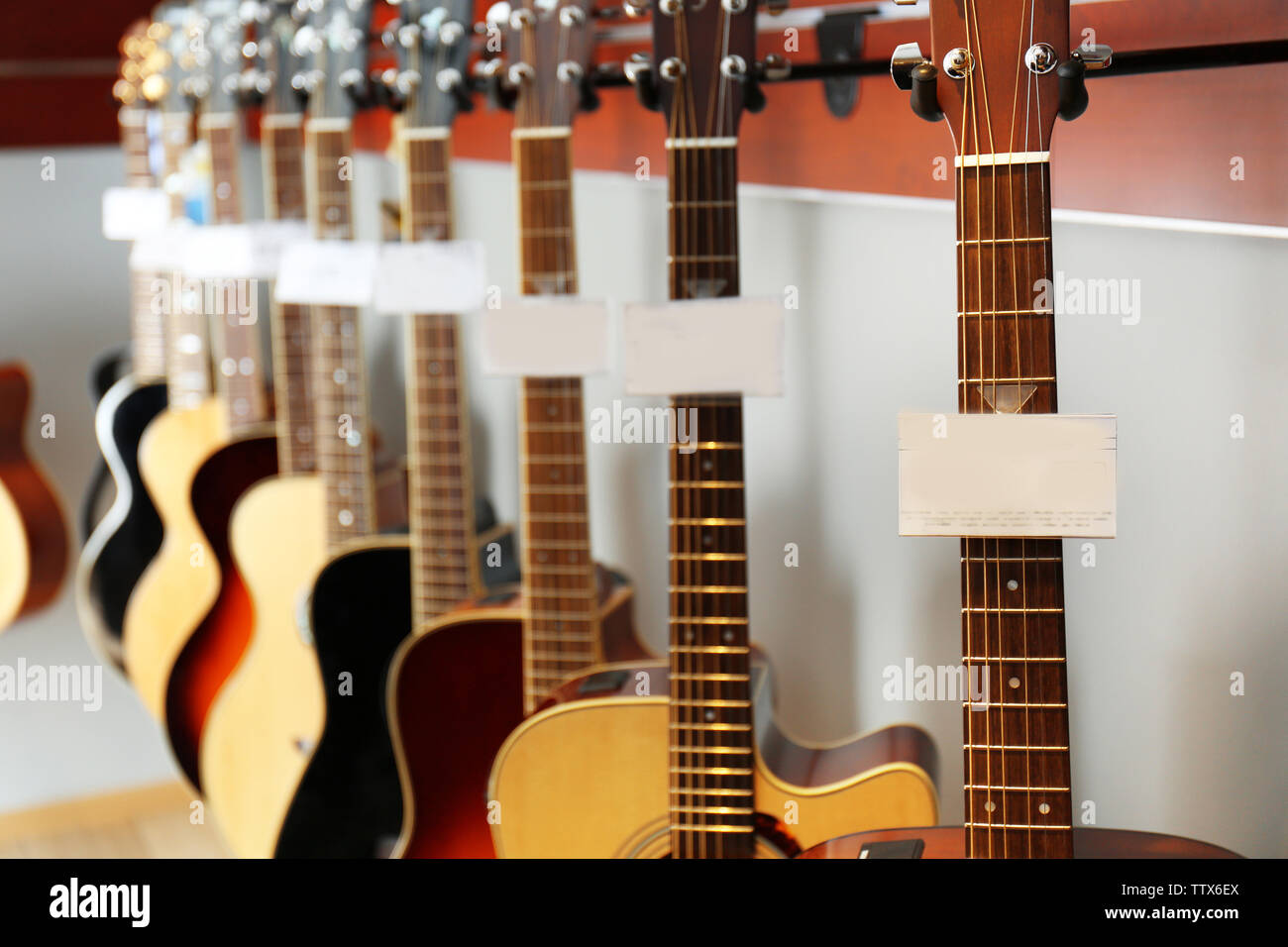 Guitars in music shop Stock Photo - Alamy