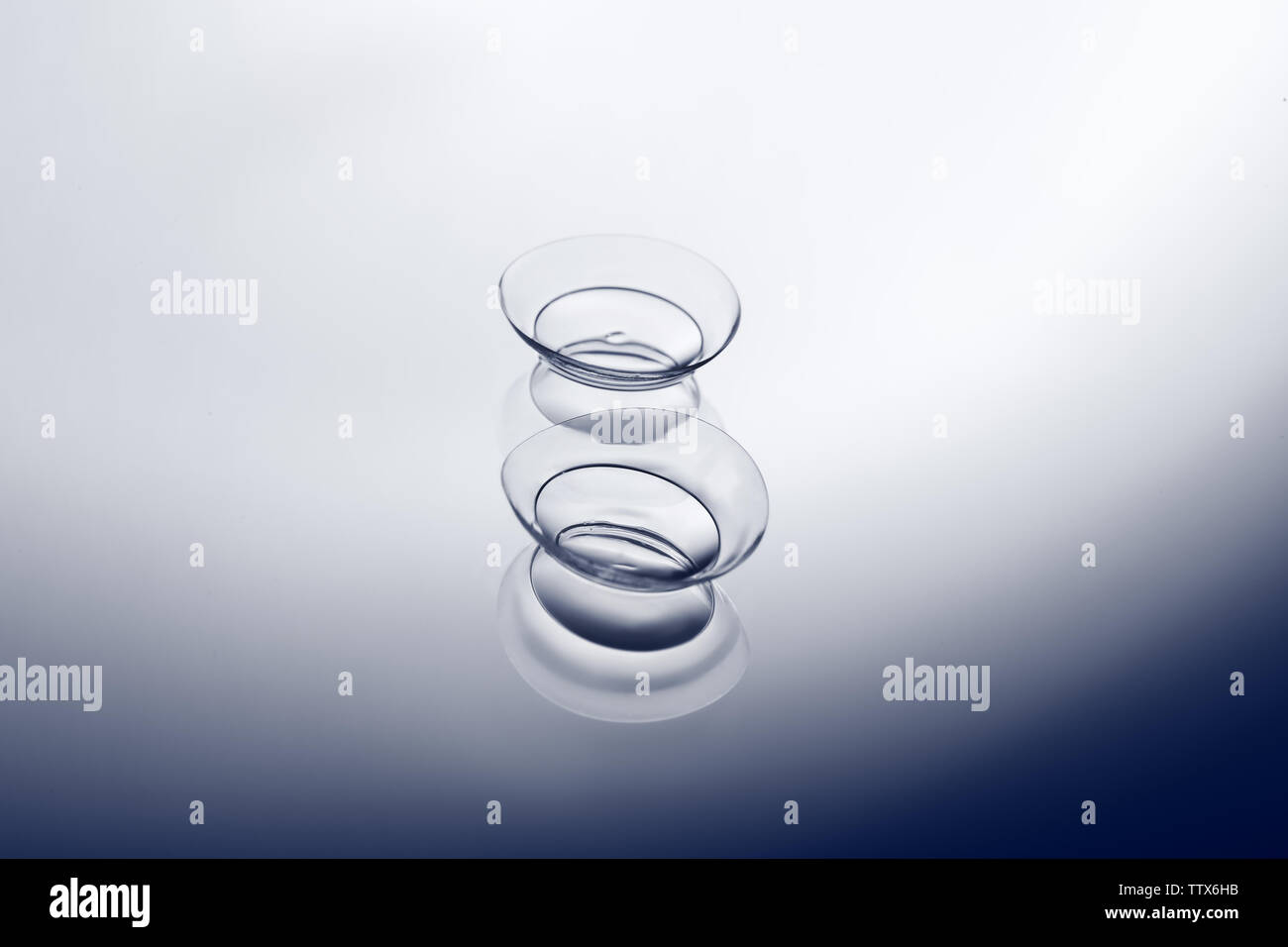 Pair of contact lenses on light background, close up view. Medicine and ...