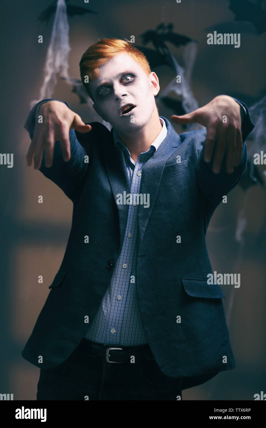 Guy dressed in dead man costume for Halloween, on dark background Stock ...