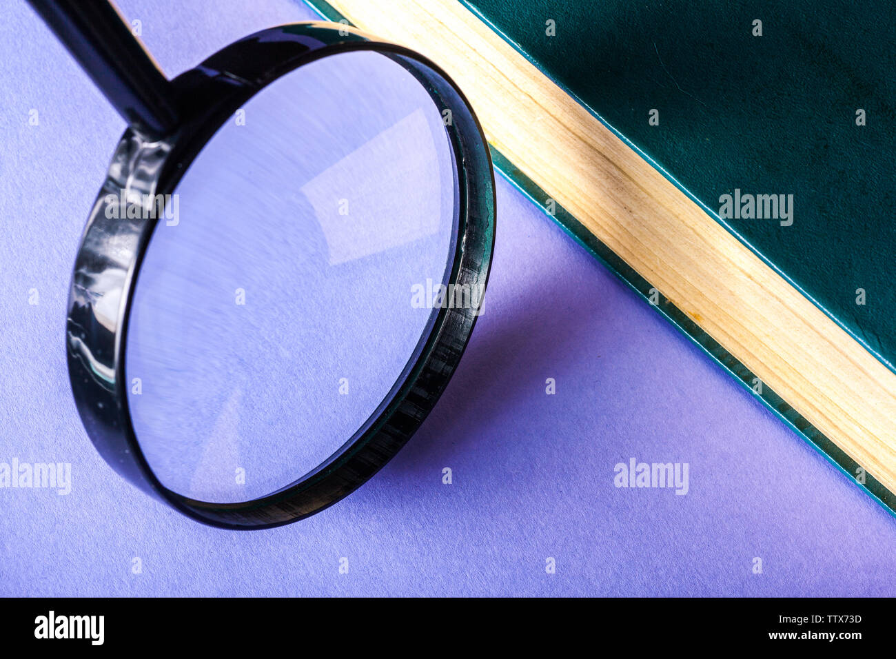books and magnifying glass Stock Photo - Alamy