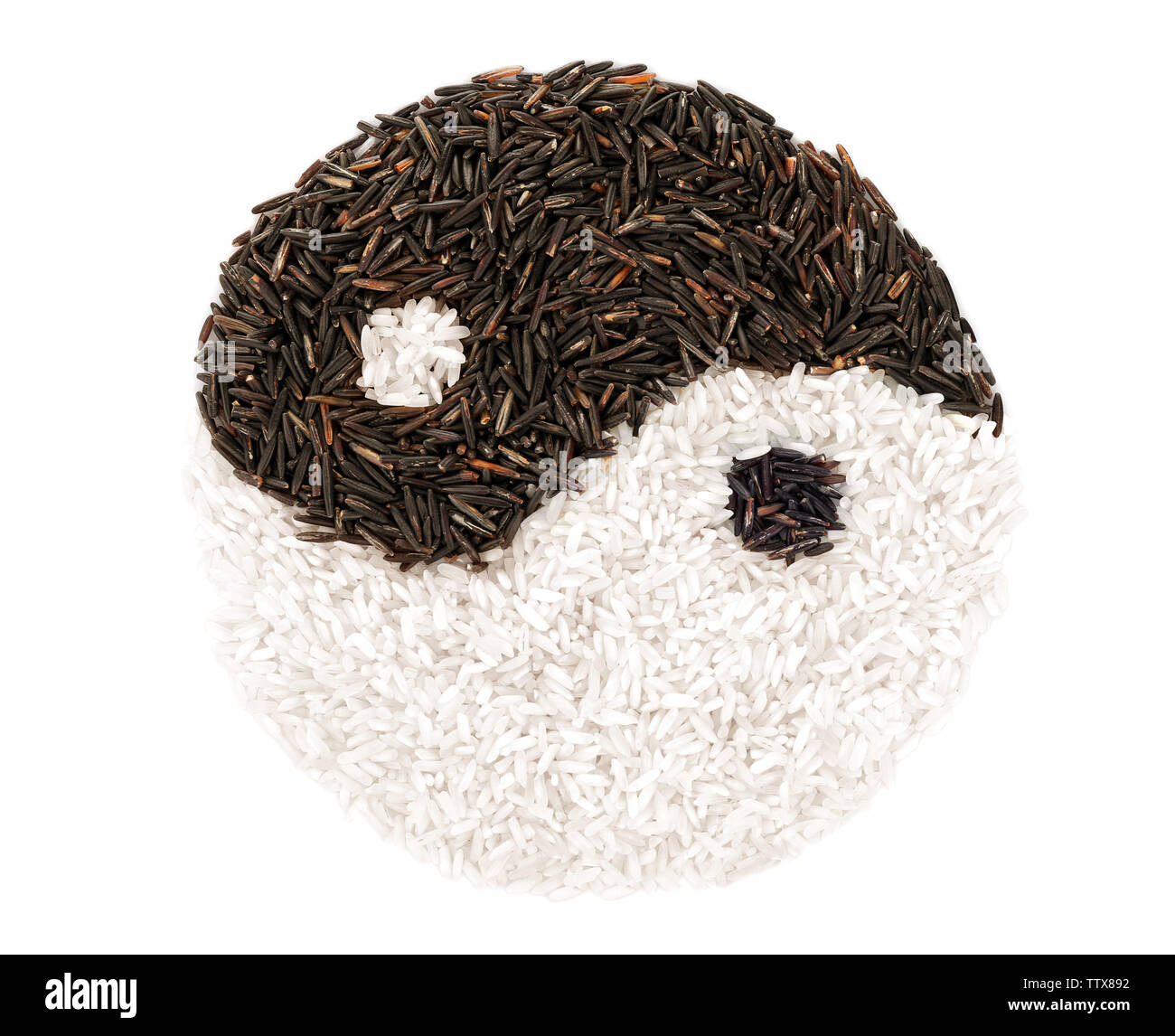 Yin Yang sign with dark wild and jasmine types of rice on white ...