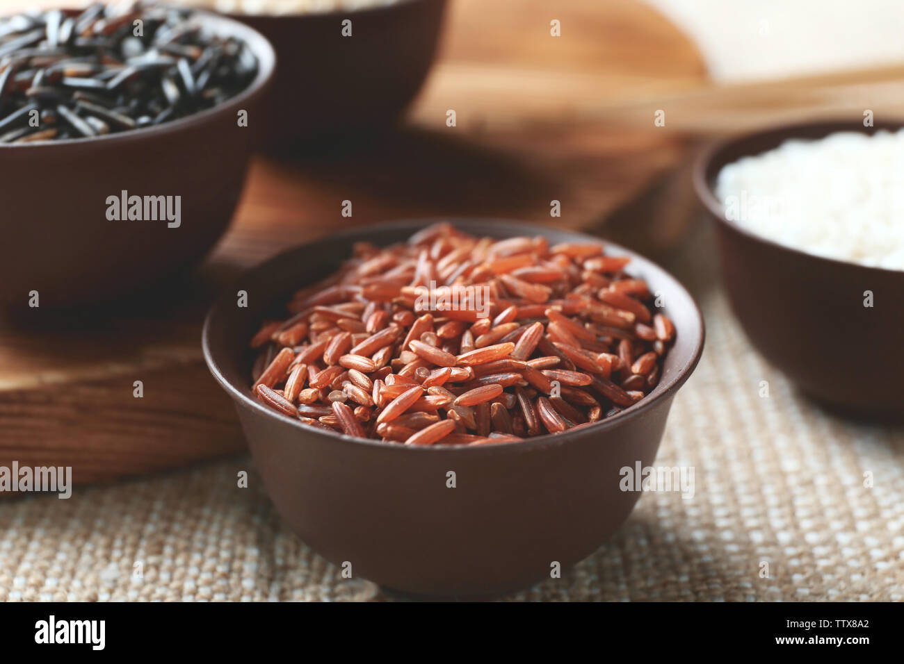 Different types of rice in small bowls closeup Stock Photo - Alamy