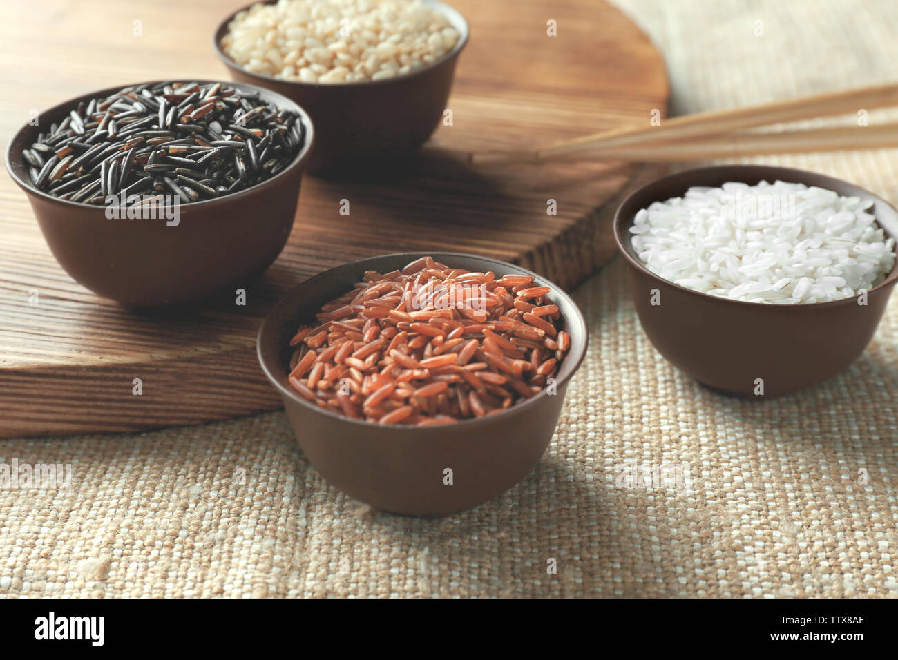 Different types of rice in small bowls closeup Stock Photo - Alamy
