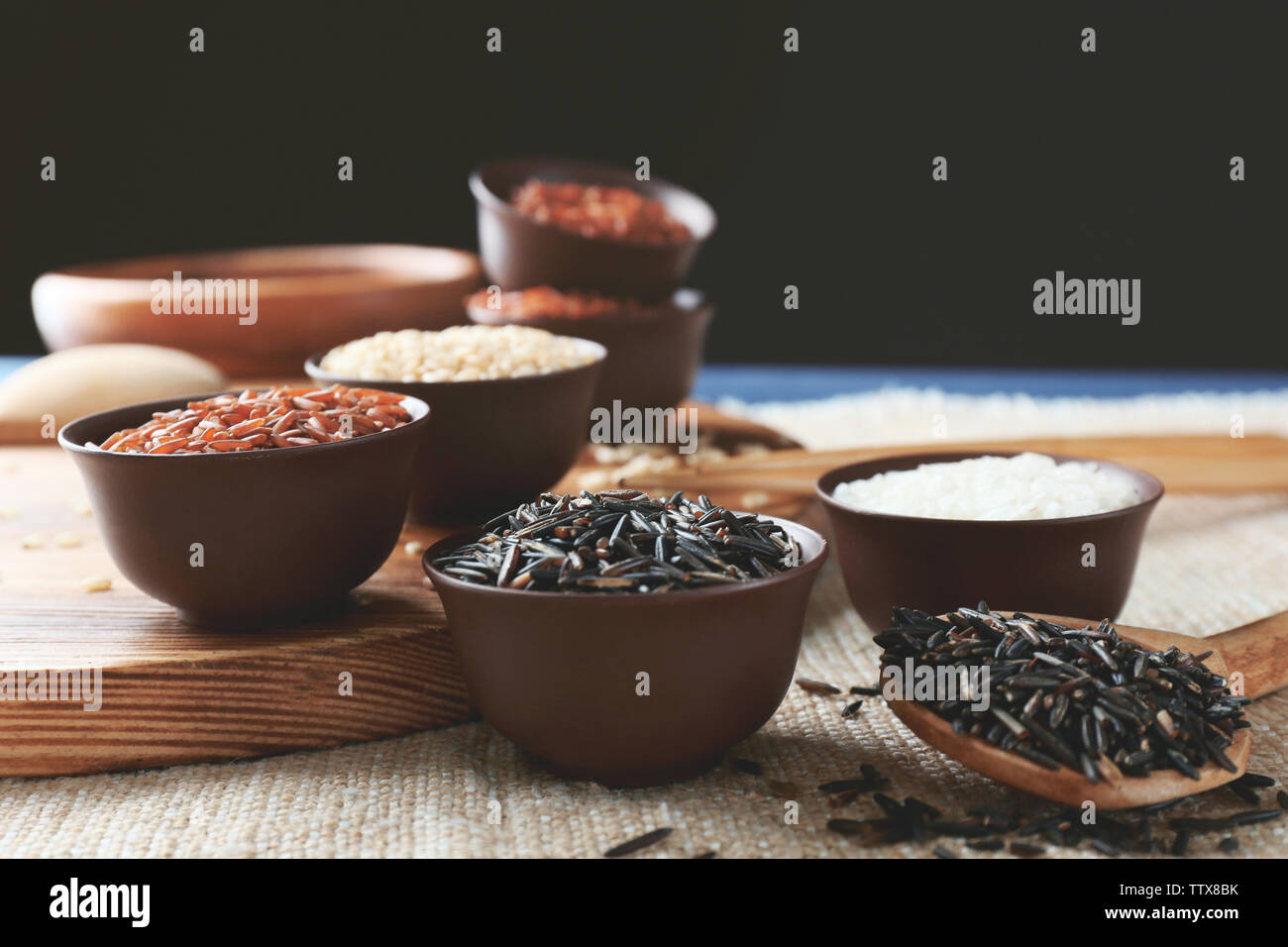 Different types of rice in small bowls closeup Stock Photo - Alamy