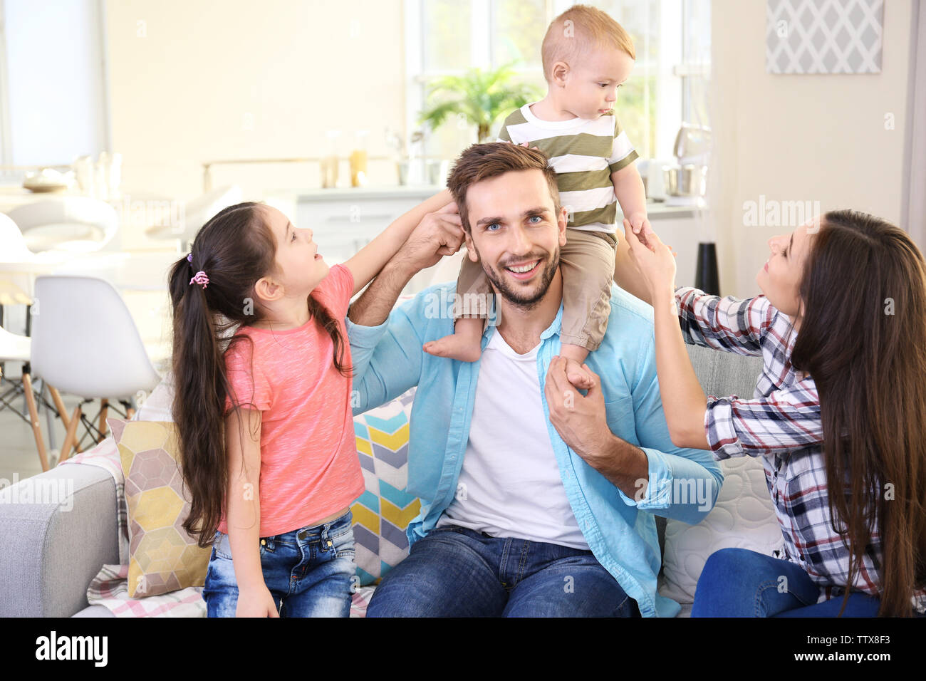 Happy family relaxing at home on weekend Stock Photo - Alamy