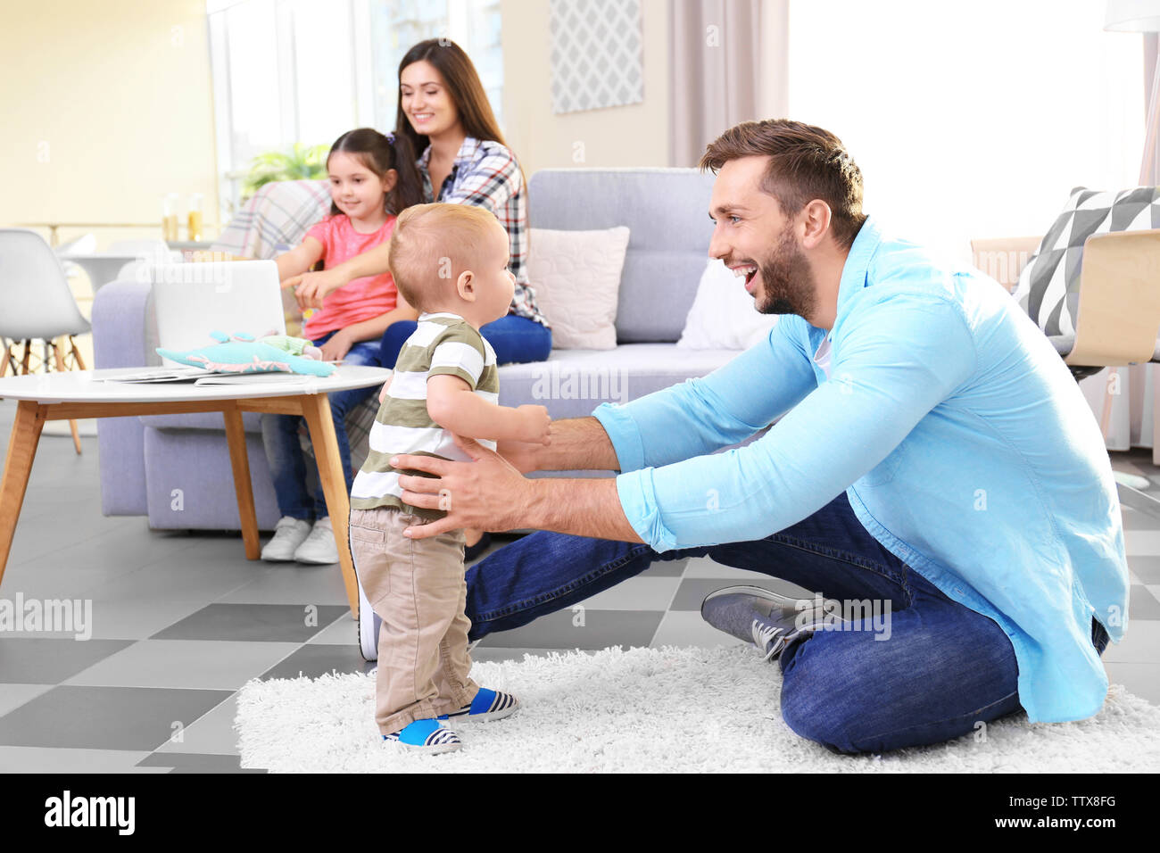 Happy family relaxing at home on weekend Stock Photo - Alamy
