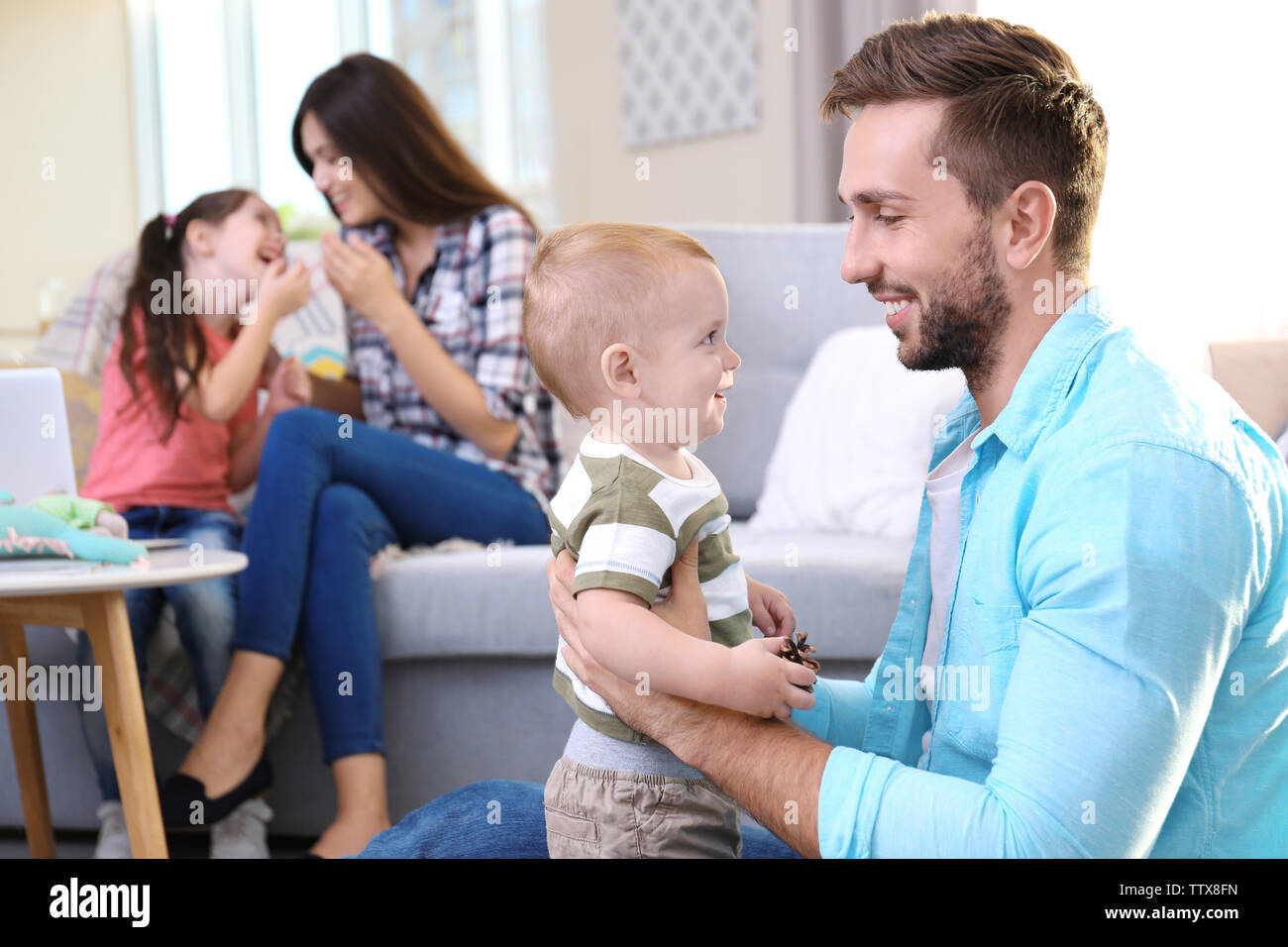 Happy family relaxing at home on weekend Stock Photo - Alamy