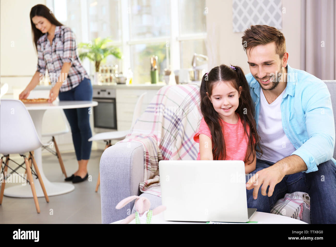 Happy family relaxing at home on weekend Stock Photo - Alamy