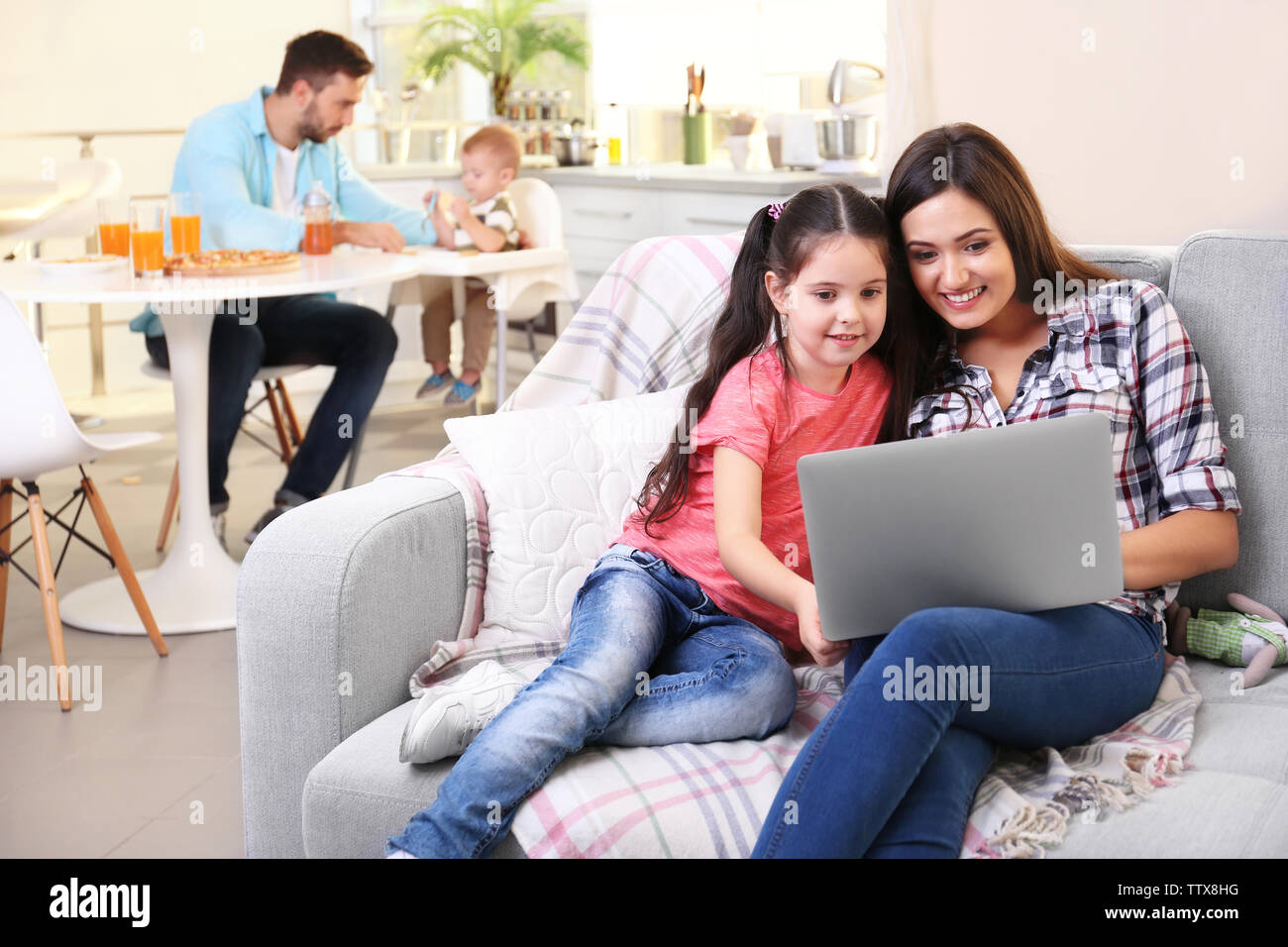 Happy family relaxing at home on weekend Stock Photo - Alamy