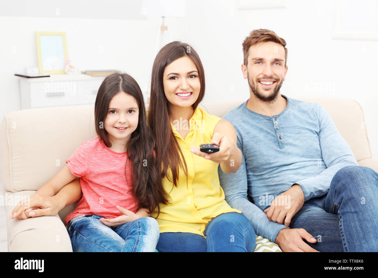 Happy family watching TV at home Stock Photo - Alamy