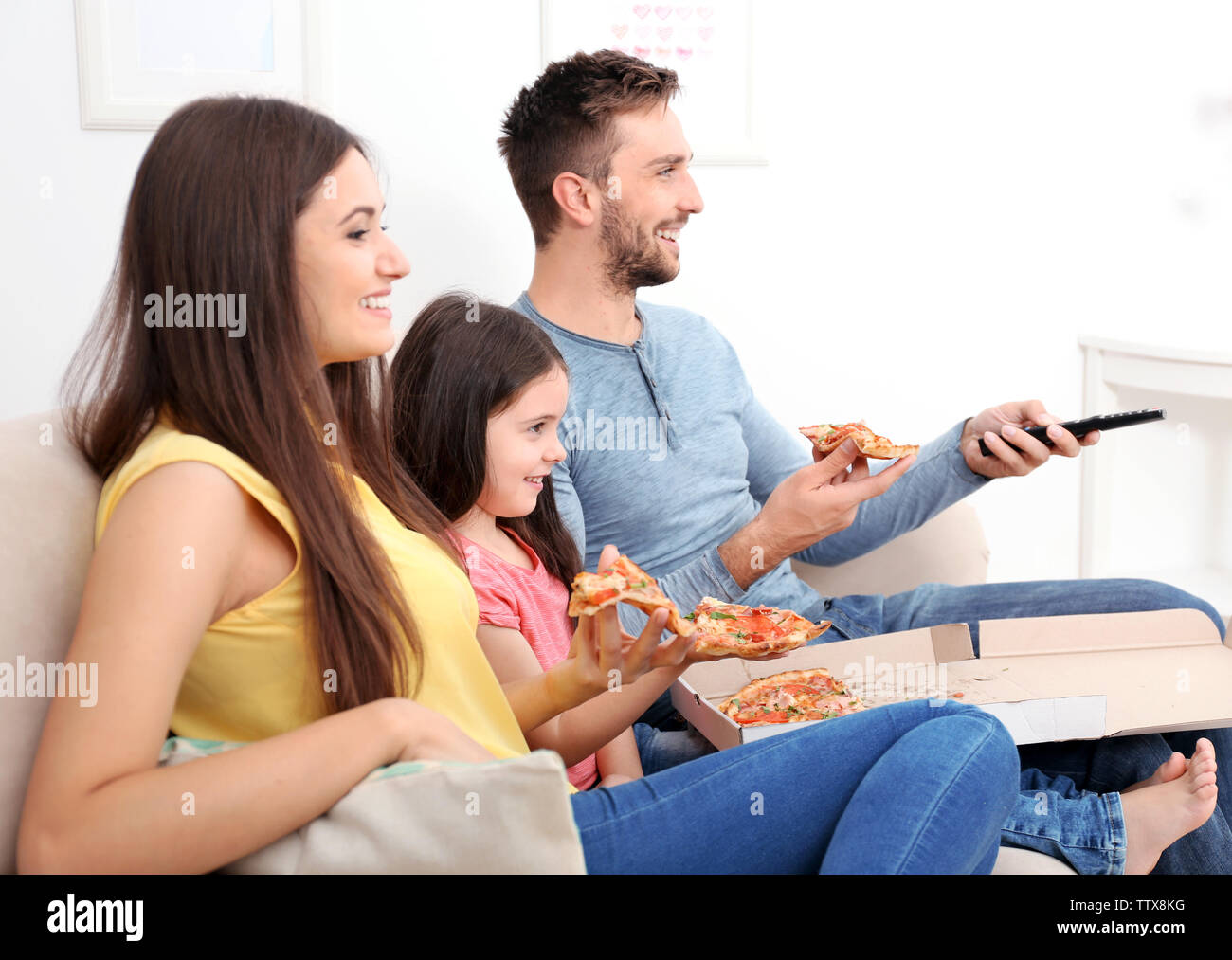 Girl eating pizza watching hi-res stock photography and images - Alamy