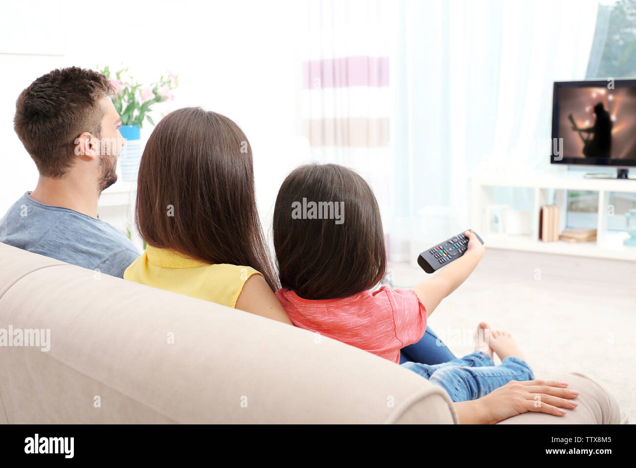 Watching tv on couch hi-res stock photography and images - Alamy