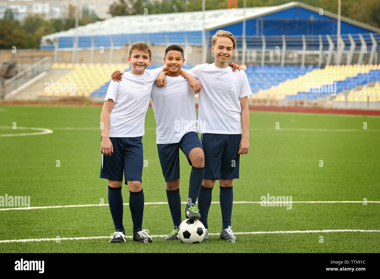 Happy football players at stadium Stock Photo - Alamy