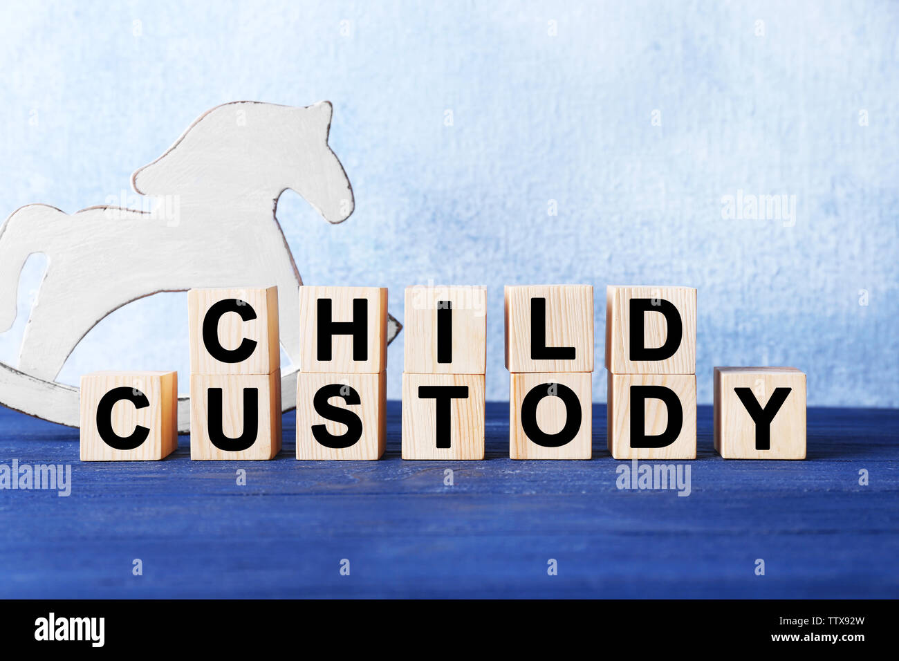 Cubes with text CHILD CUSTODY and toy on light background Stock Photo ...