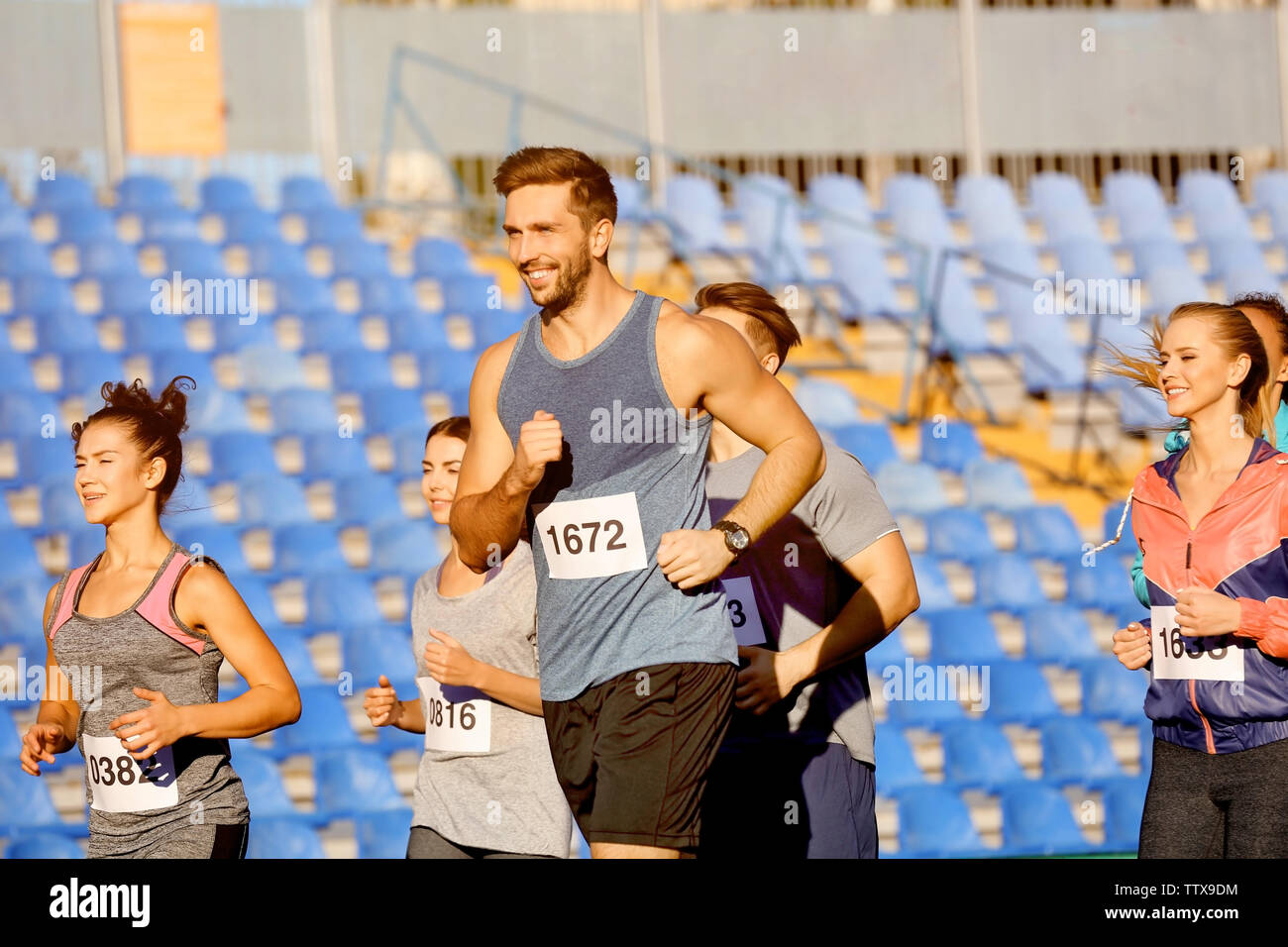 Sportsmen running at stadium Stock Photo - Alamy
