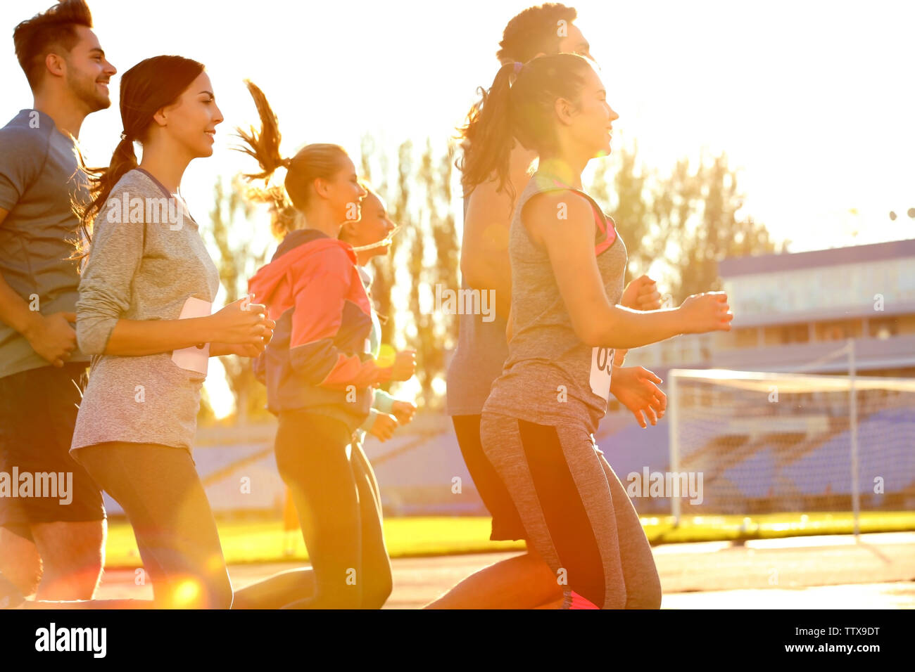 Sportsmen running at stadium Stock Photo - Alamy