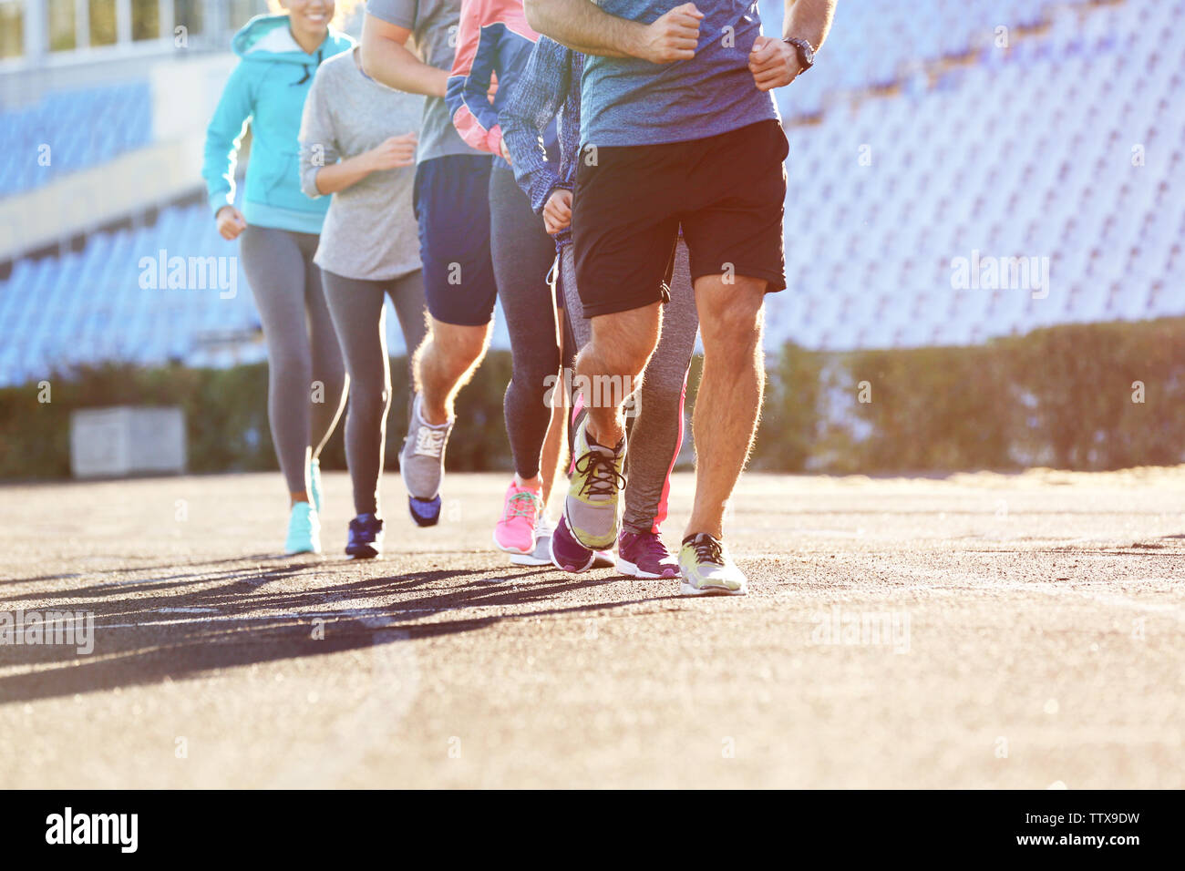 Sportsmen running at stadium Stock Photo - Alamy