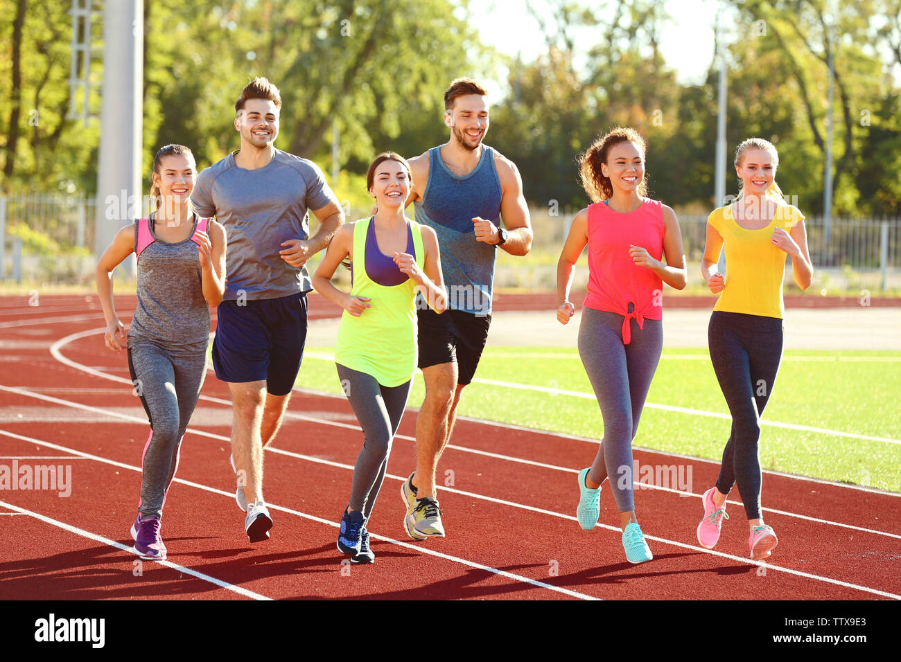 Sportsmen running at stadium Stock Photo - Alamy