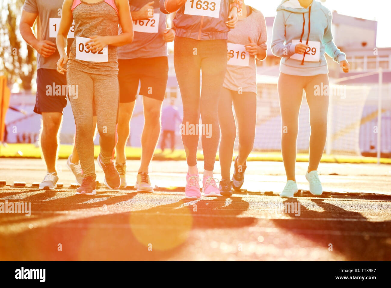 Sportsmen running at stadium Stock Photo - Alamy