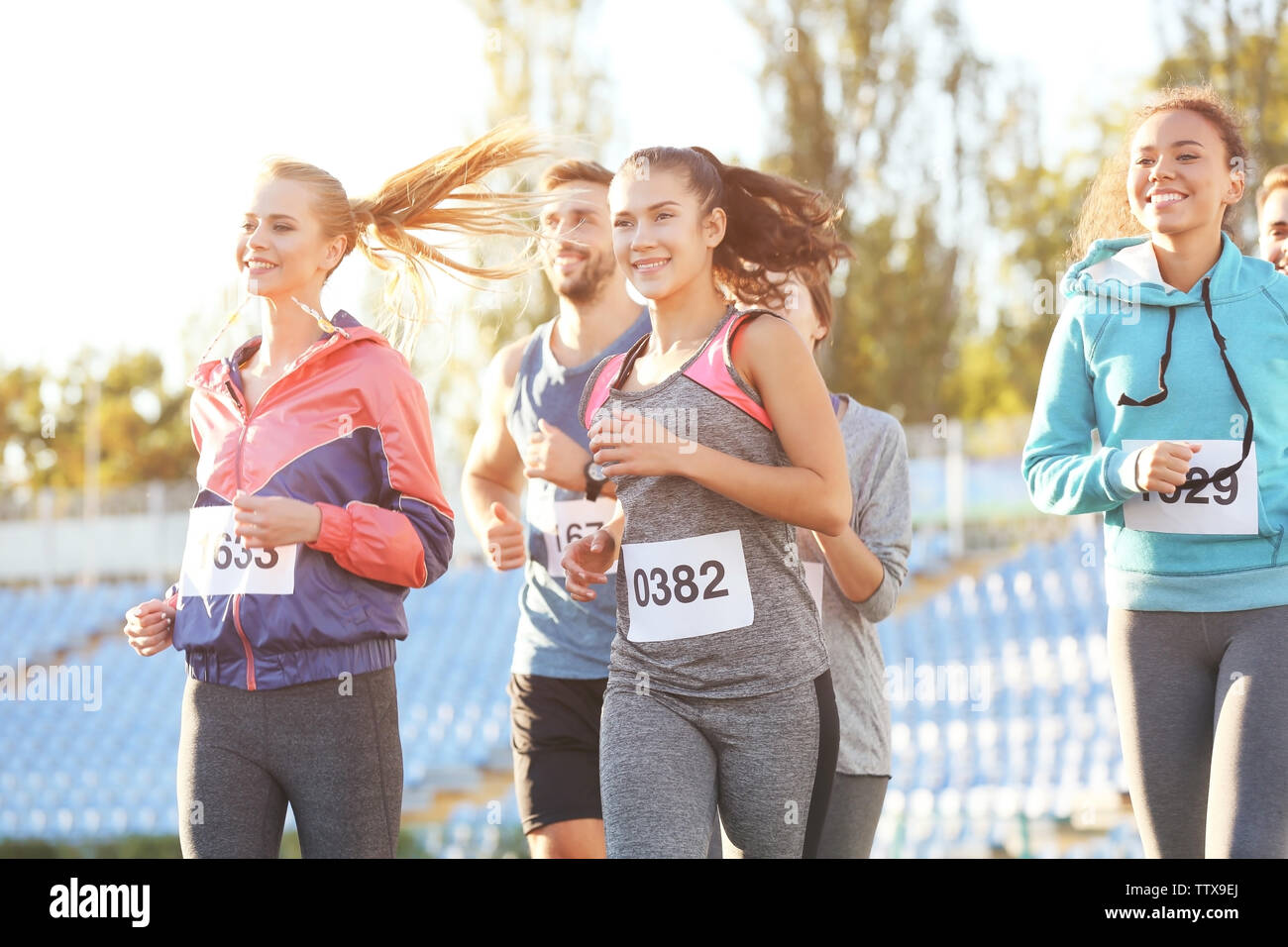 Sportsmen running at stadium Stock Photo - Alamy