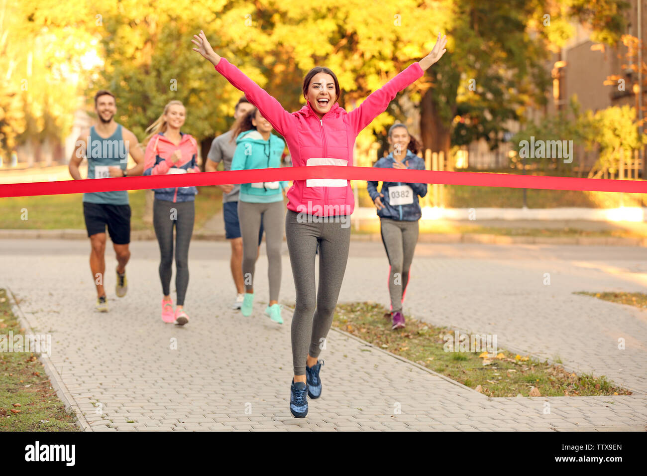 Woman running in park winner hi-res stock photography and images - Alamy