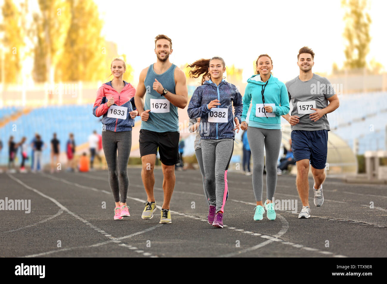 Sportsmen running at stadium Stock Photo - Alamy