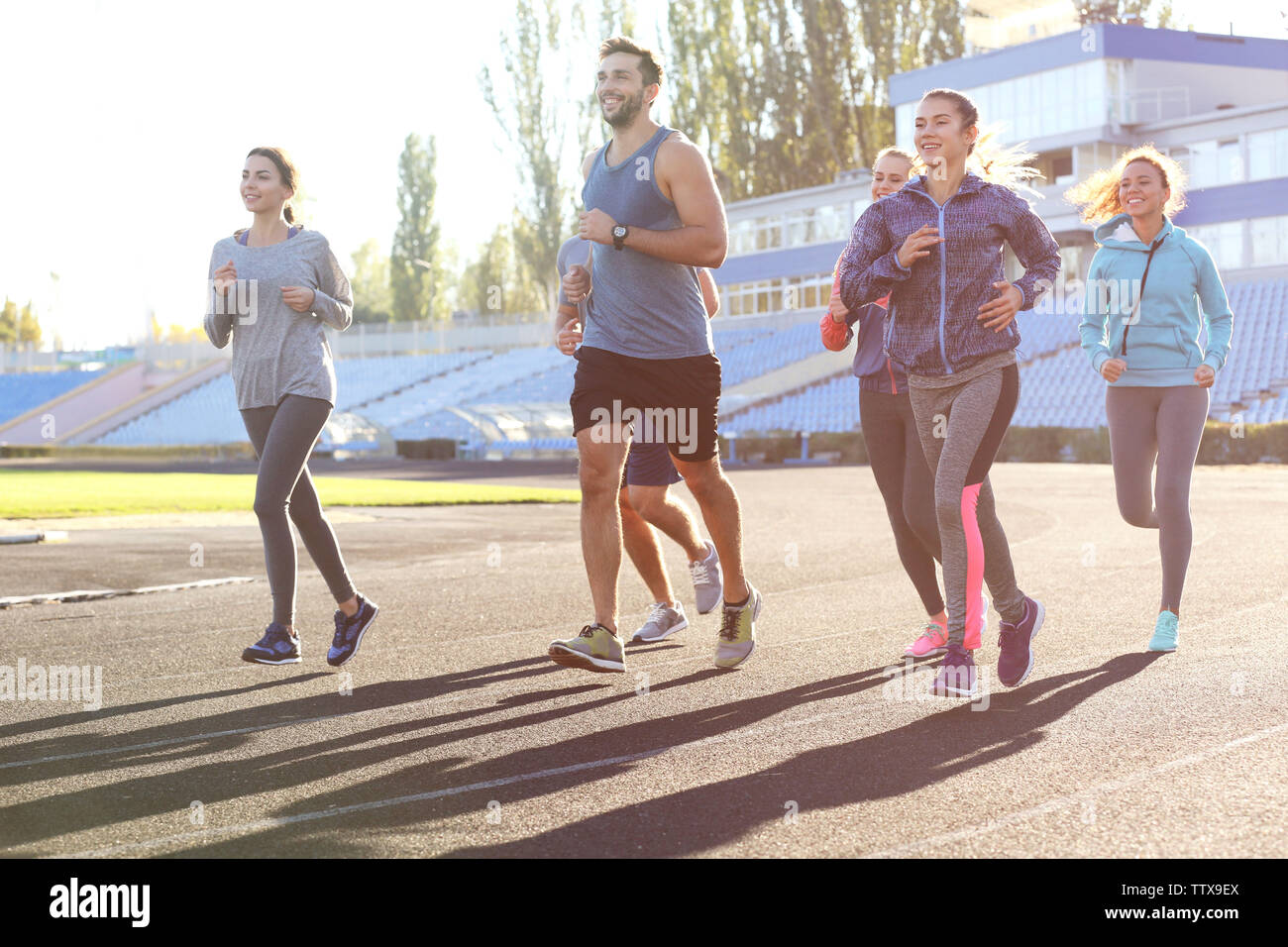 Sportsmen running at stadium Stock Photo - Alamy