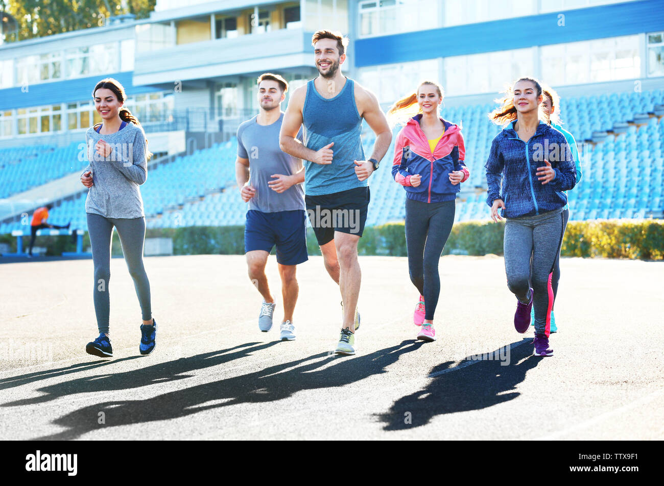Sportsmen running at stadium Stock Photo - Alamy