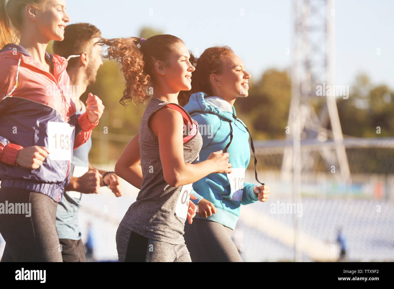 Sportsmen running at stadium Stock Photo - Alamy