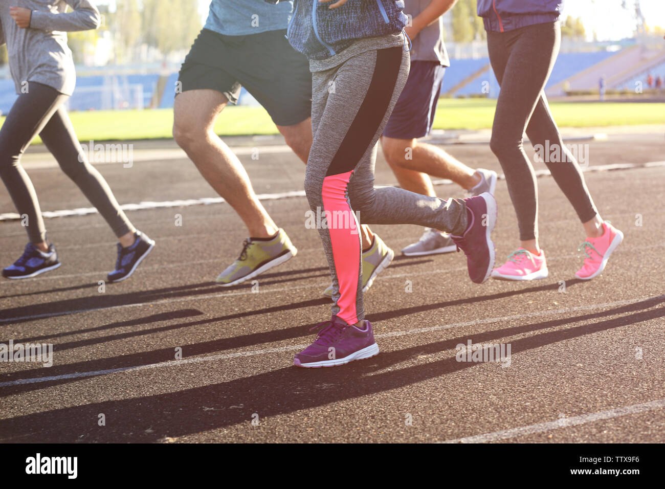 Sportsmen running at stadium Stock Photo - Alamy