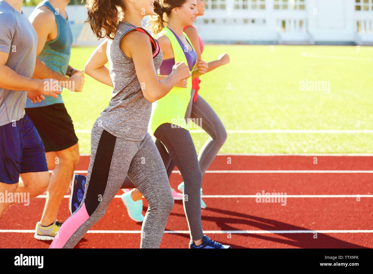 Sportsmen running at stadium Stock Photo - Alamy