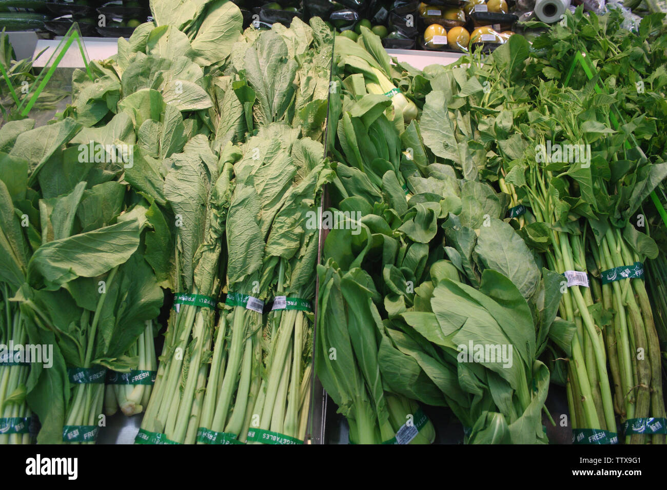 Bundles of leaf vegetables in a supermarket, Bangkok, Thailand Stock ...