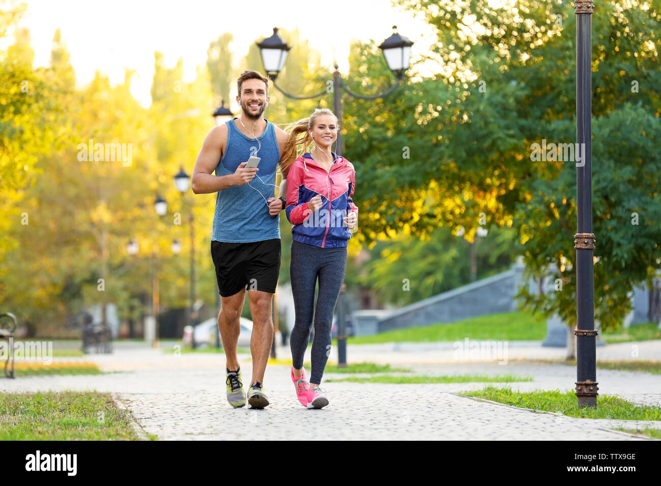 Sportsmen running in park hi-res stock photography and images - Alamy