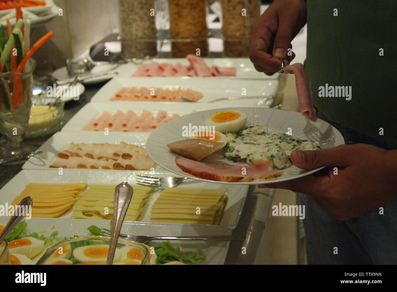 Man getting food from a buffet table, Bangkok, Thailand Stock Photo - Alamy