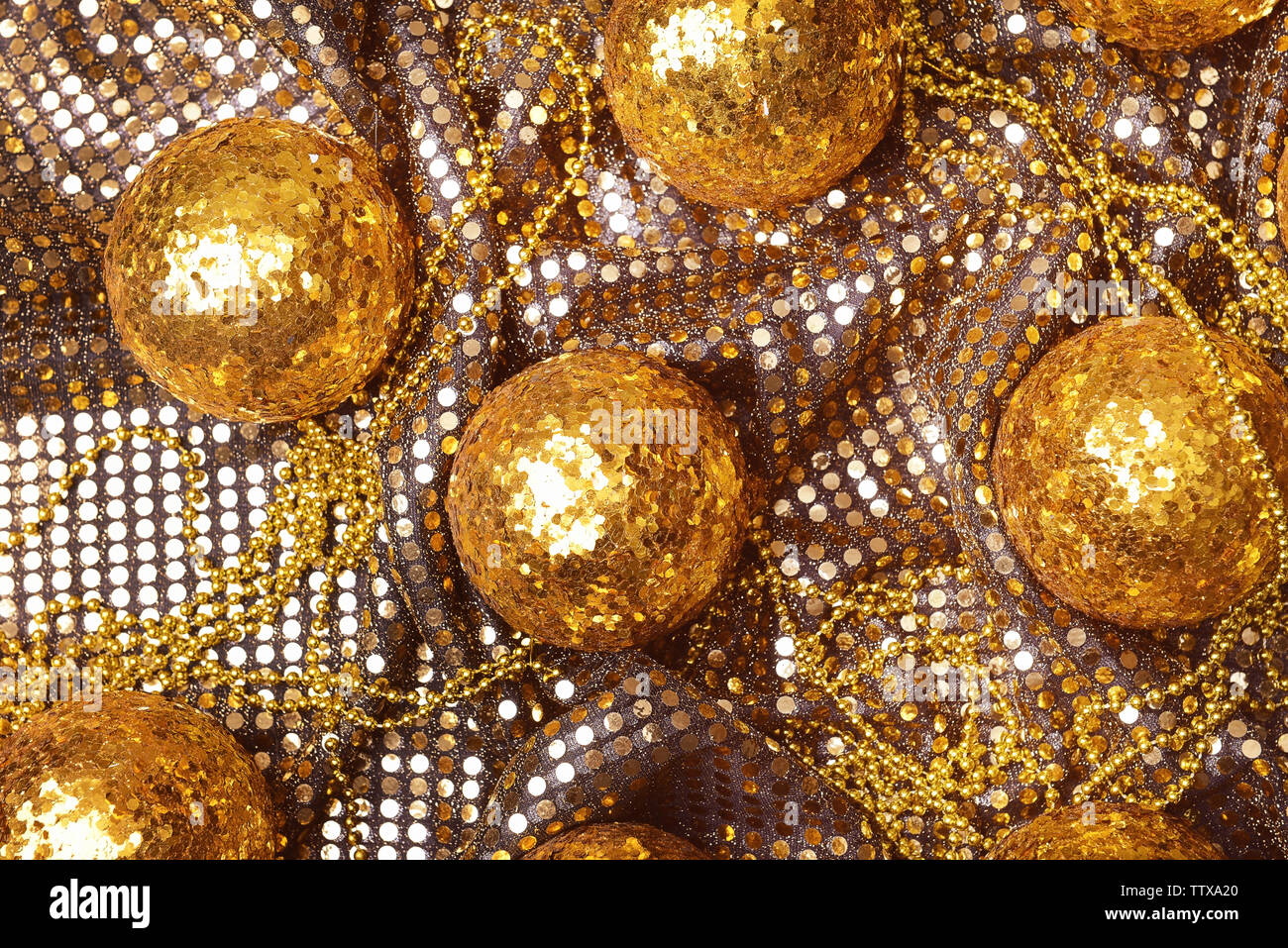 Beautiful golden baubles and beads on sparkling cloth Stock Photo - Alamy