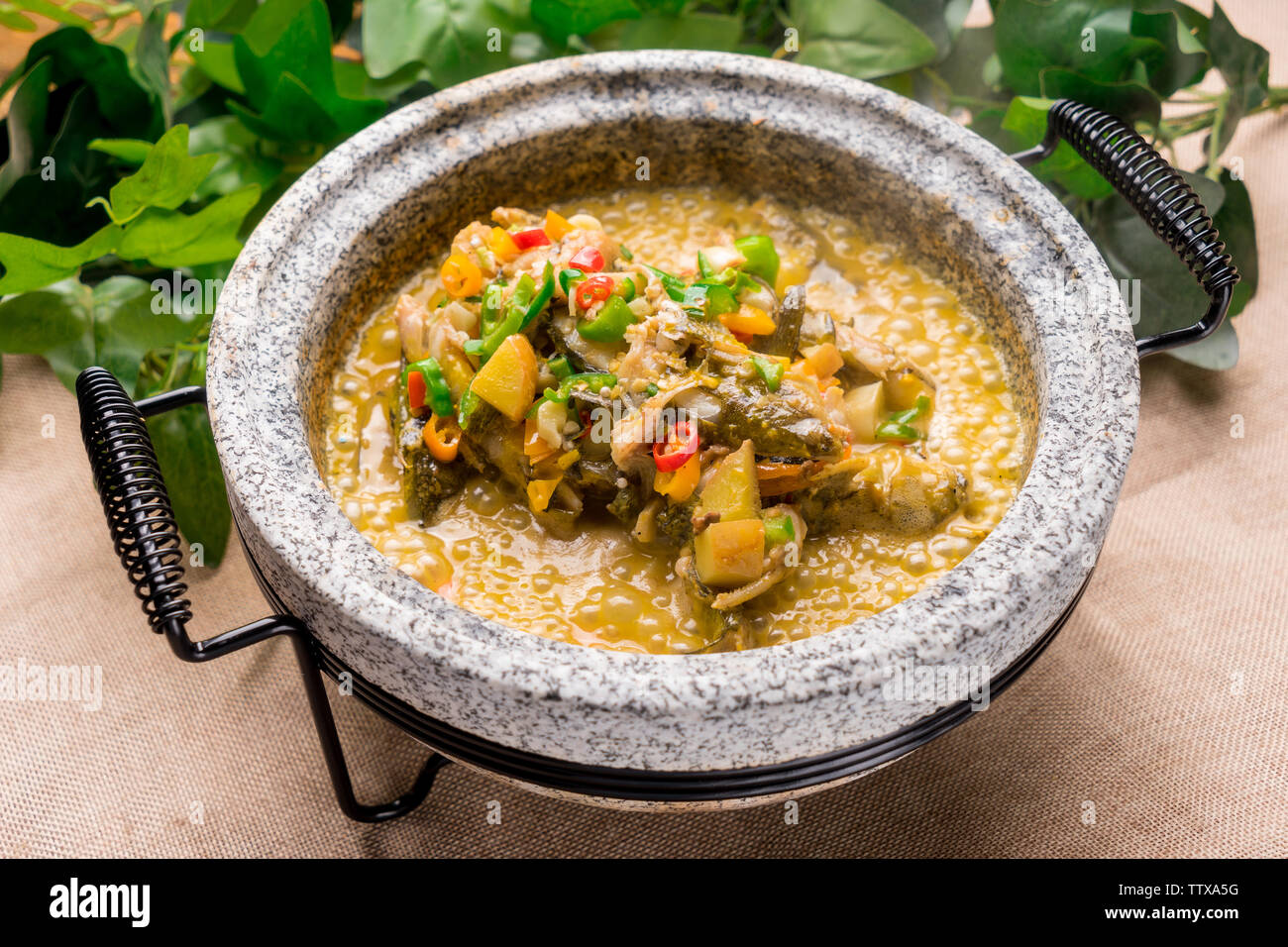 Traditional gourmet stone pot fish Stock Photo - Alamy