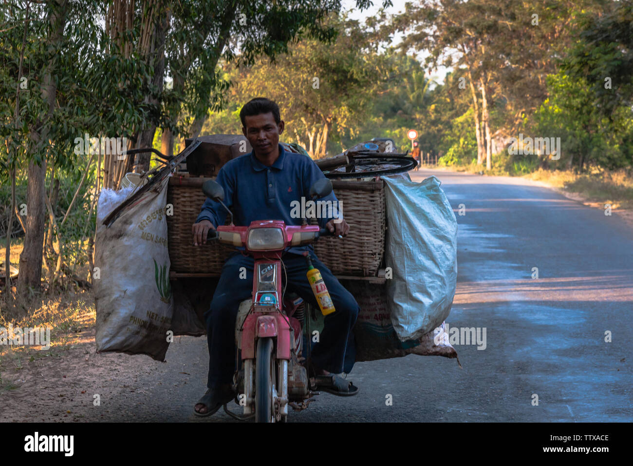 A man driving the overloaded motorcycle near Siem Reap, Cambodia Stock ...