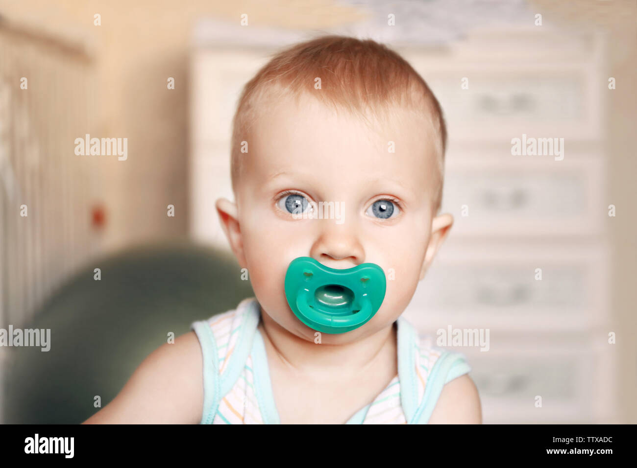 Cute little boy with dummy at home Stock Photo - Alamy