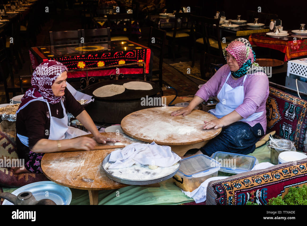Two Turkish women making traditional flatbread, lavash, in Istanbul ...