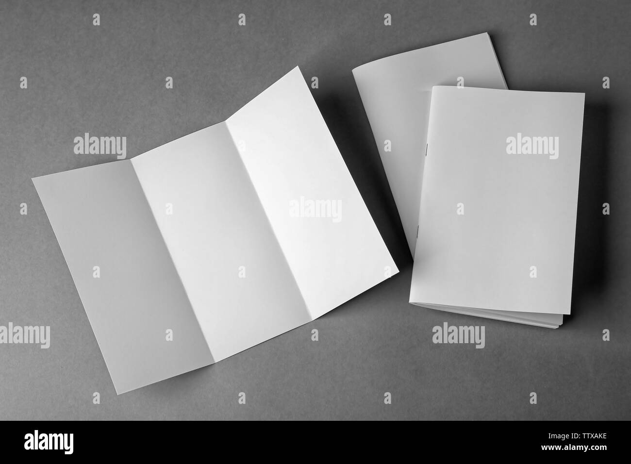 Blank brochures and booklet on grey background Stock Photo - Alamy