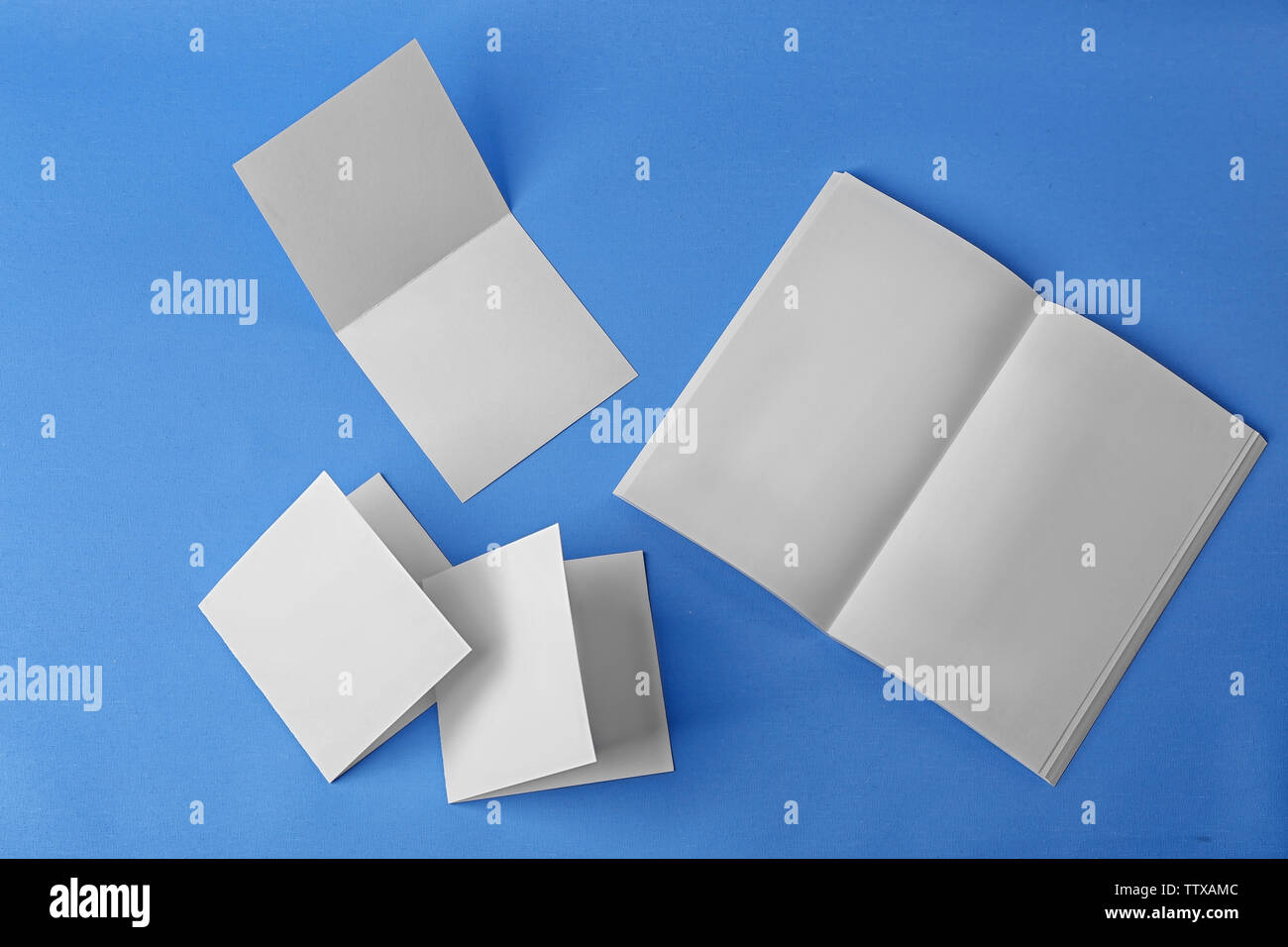 Blank brochure and booklets on blue background Stock Photo - Alamy