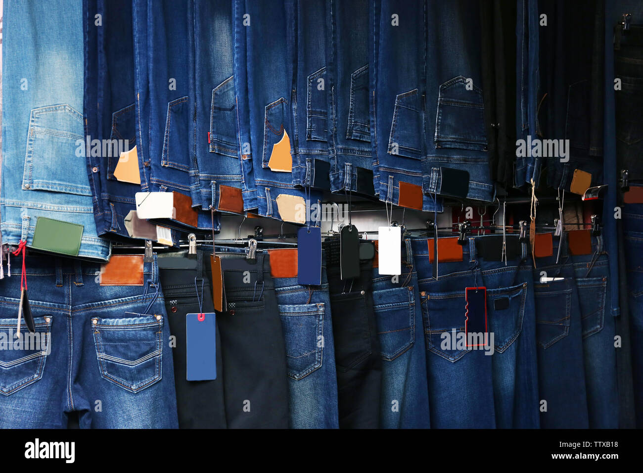 Denim clothes in clothing store Stock Photo - Alamy