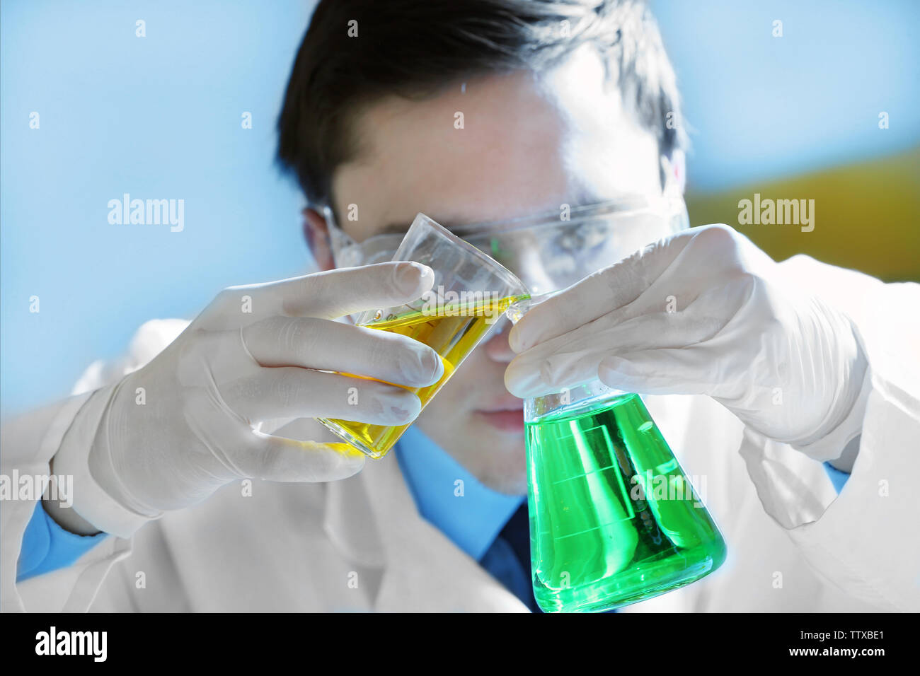 Young male scientist making experiments in laboratory Stock Photo - Alamy