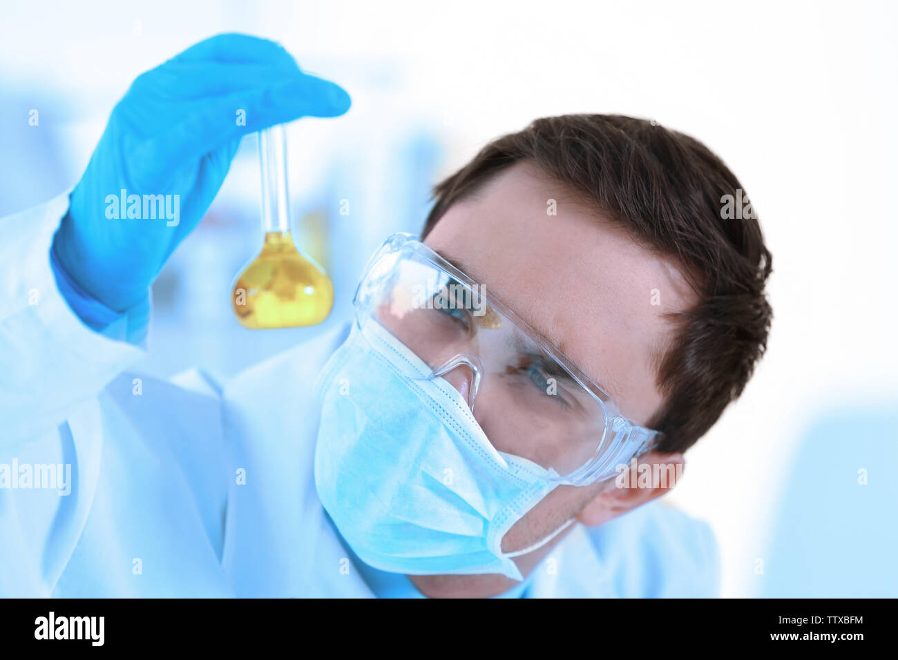 Young male scientist making experiments in laboratory Stock Photo - Alamy