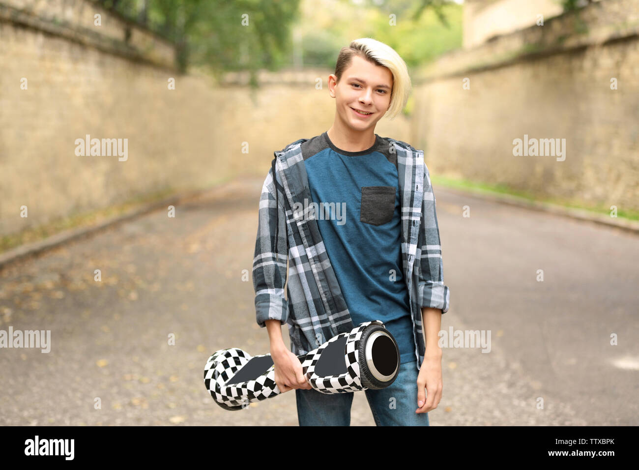 Teenager boy with hoverboard outdoors Stock Photo - Alamy