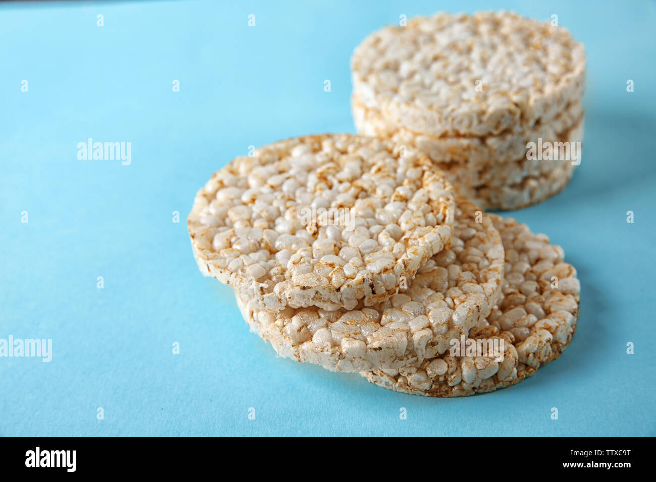 Rice crackers on blue background Stock Photo - Alamy