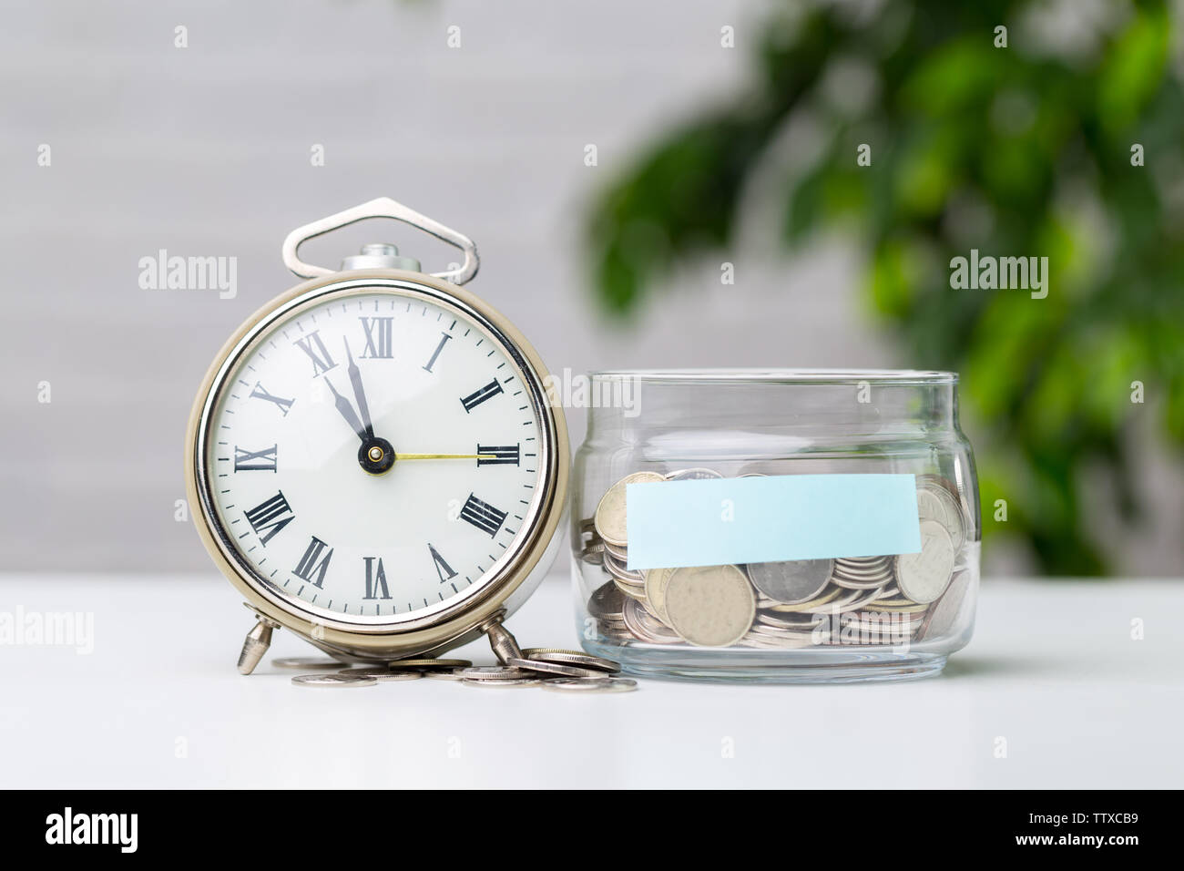 Stack coins alarm clock hi-res stock photography and images - Alamy