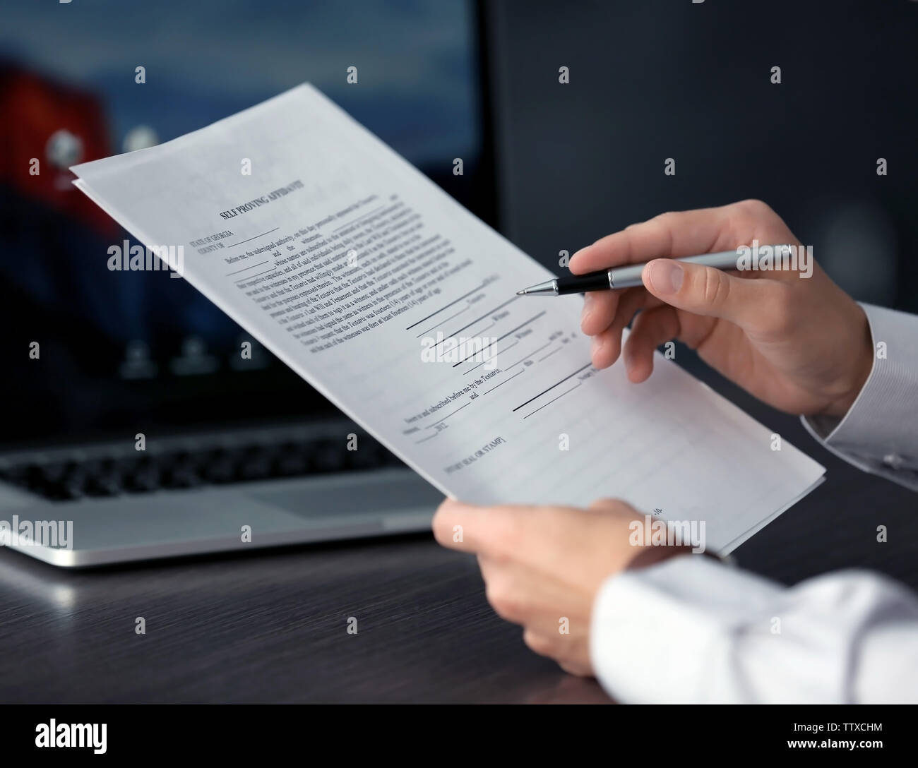 Businessman reading documents Stock Photo - Alamy