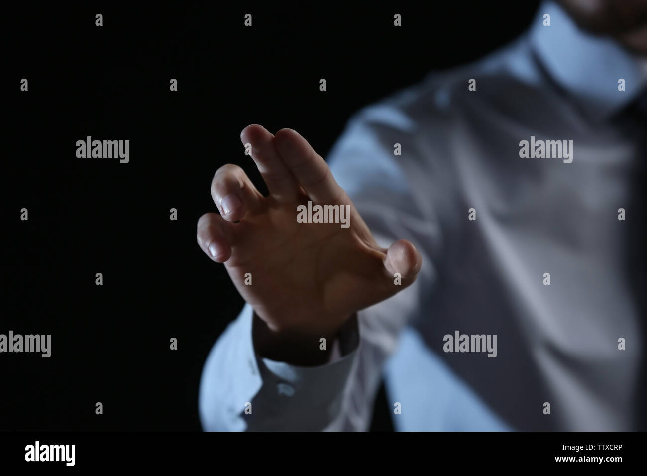 Businessman hand pointing, black background Stock Photo - Alamy