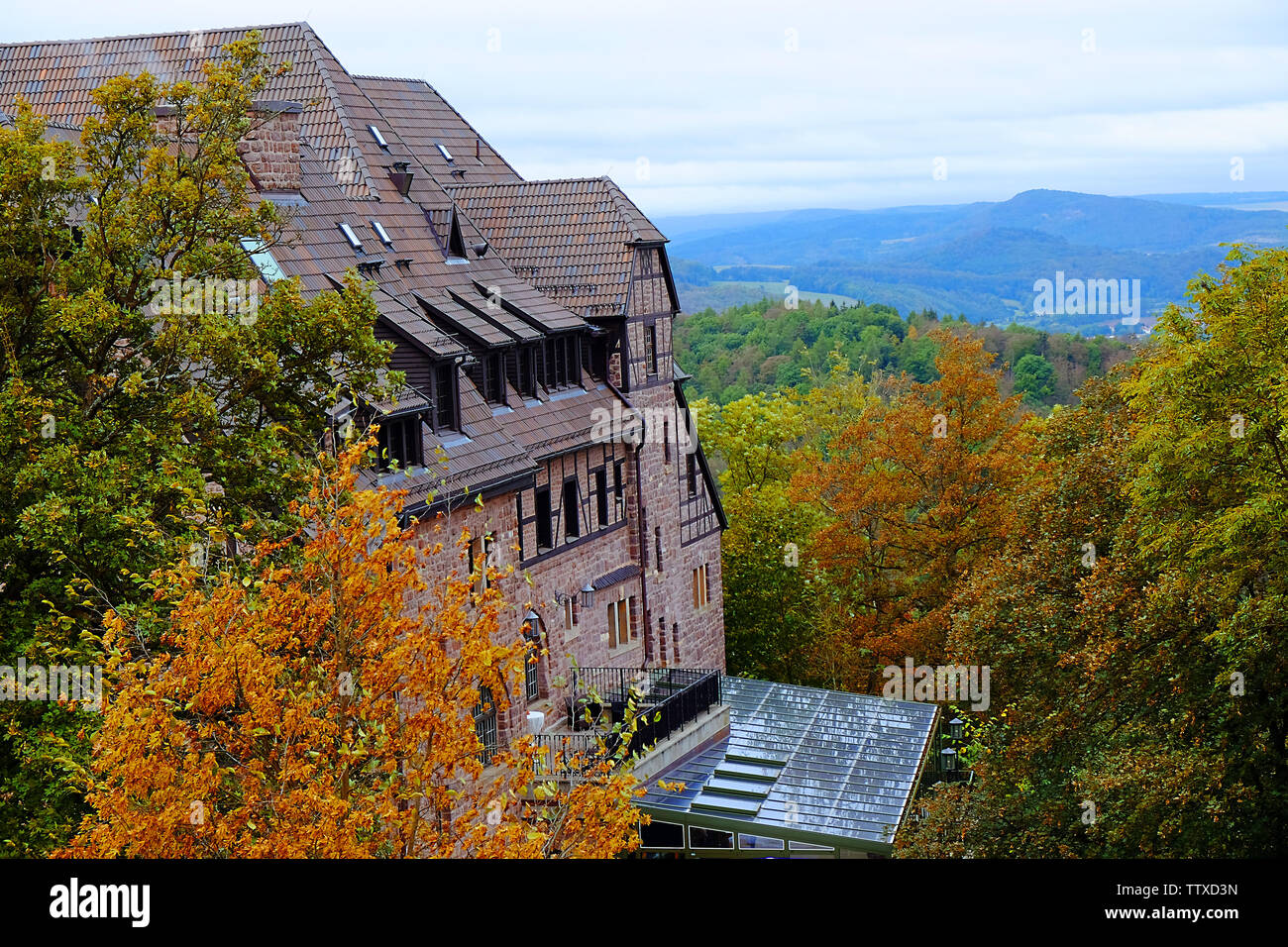 Big beautiful building among green trees Stock Photo - Alamy